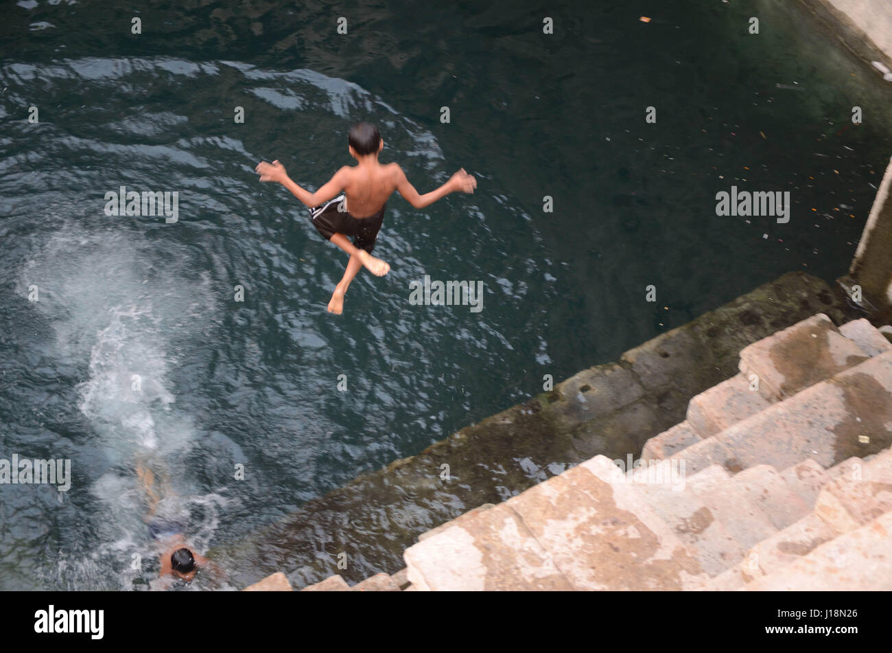 Boy jumping in well, jodhpur, rajasthan, india, asia Stock Photo - Alamy