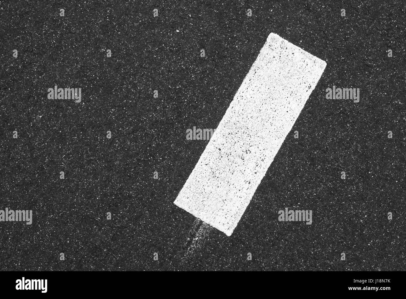 White rectangle on dark gray tarmac, highway road marking. Abstract ...