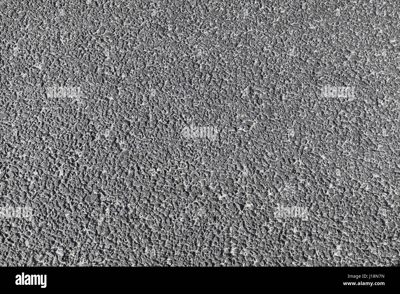 Tarmac road pavement consisting of crushed rock mixed with tar ...