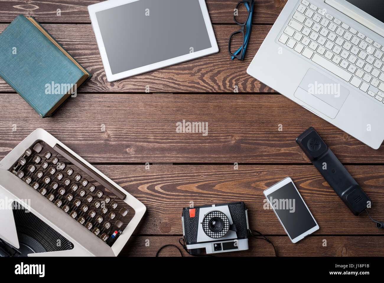Old and modern devices on wooden table. Technology progress concept ...