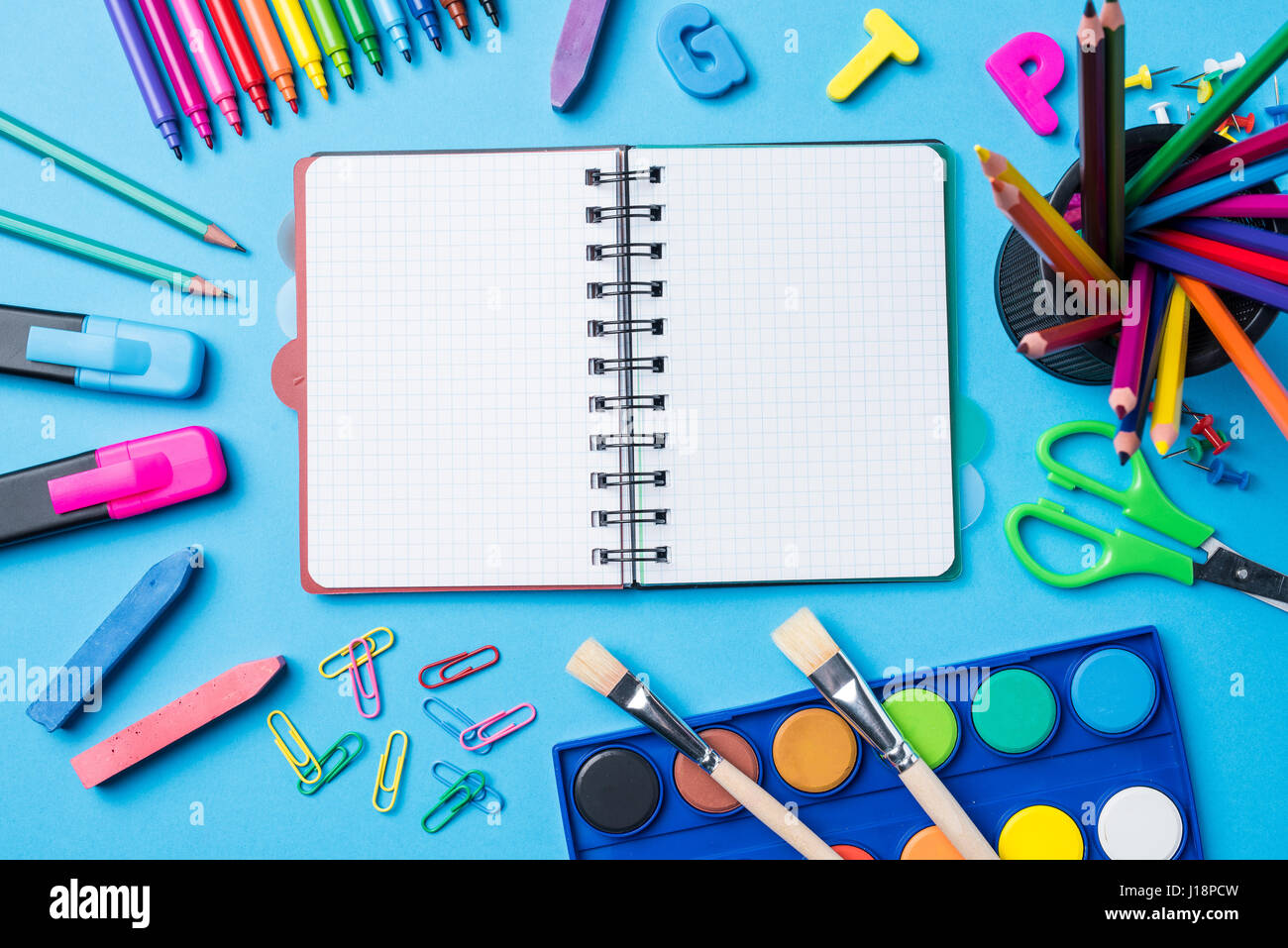 Overhead shot of school supplies on blue background Stock Photo - Alamy