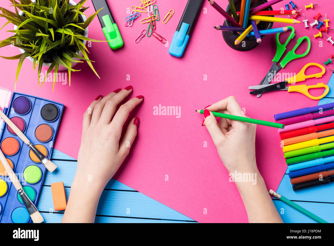 Woman's hand drawing on pink paper. School or art background Stock ...