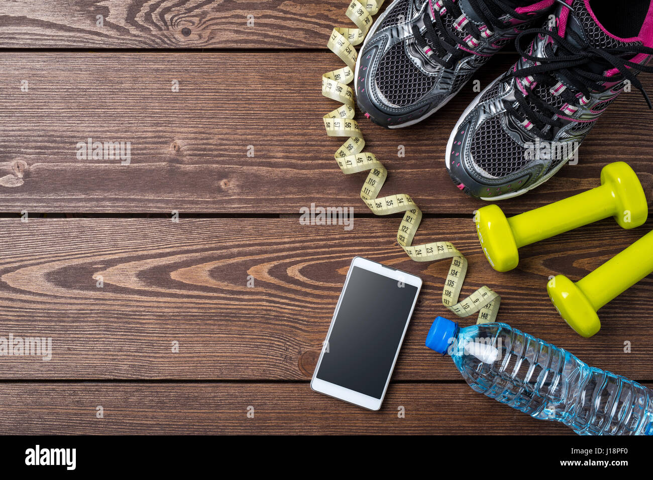 Fitness background with sport equipment on wooden floor. Top view Stock ...