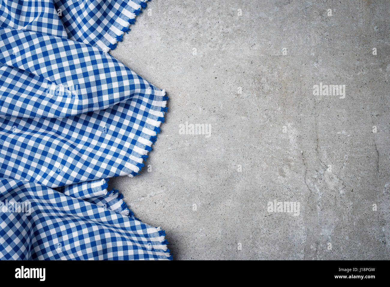 Blue folded tablecloth on gray stone table Stock Photo - Alamy