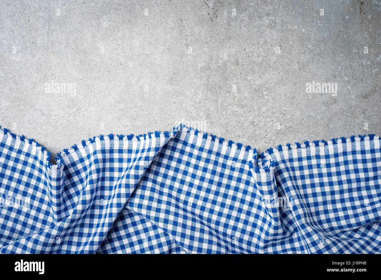 Blue folded tablecloth on gray stone table Stock Photo - Alamy