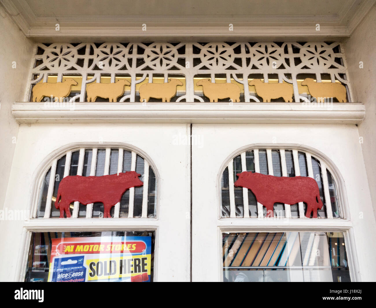 Door and door frame detail of a previous butcher's shop fascia with cut ...