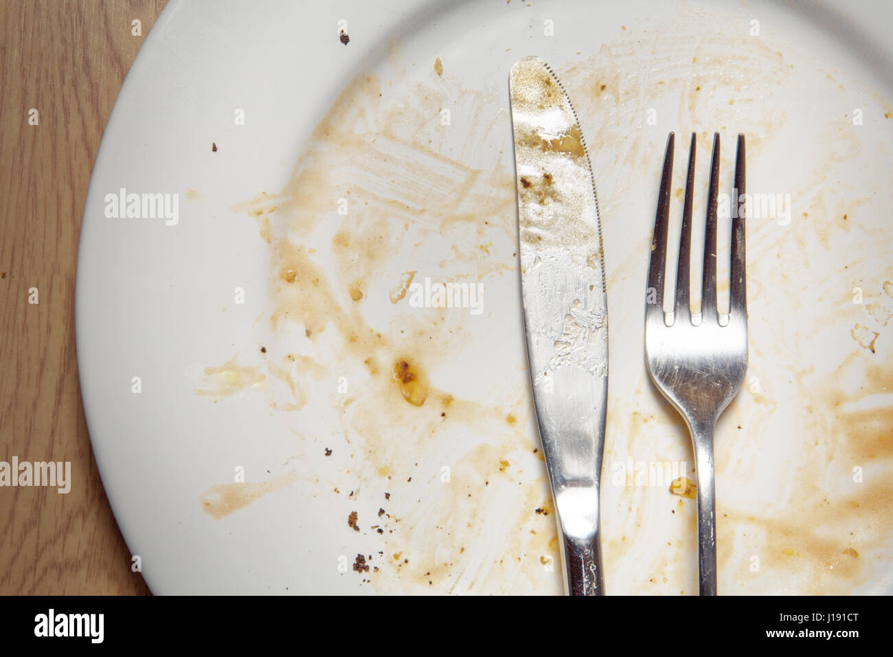 single dirty dinner plate on table top looking down from above Stock ...