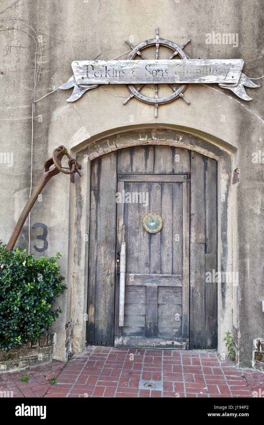 Old fishing boat style door on historic building Stock Photo - Alamy