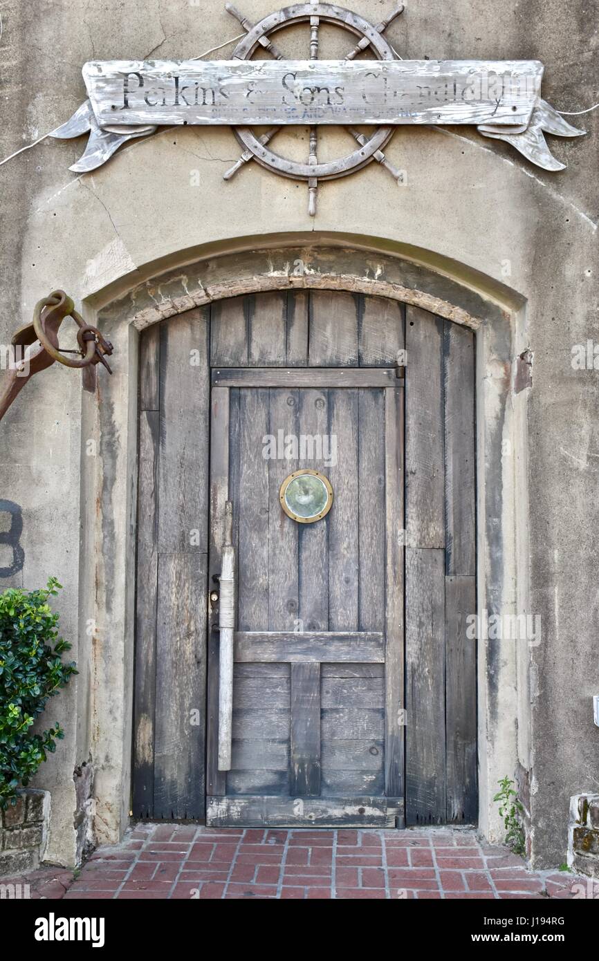 Old fishing boat style door on historic building Stock Photo - Alamy