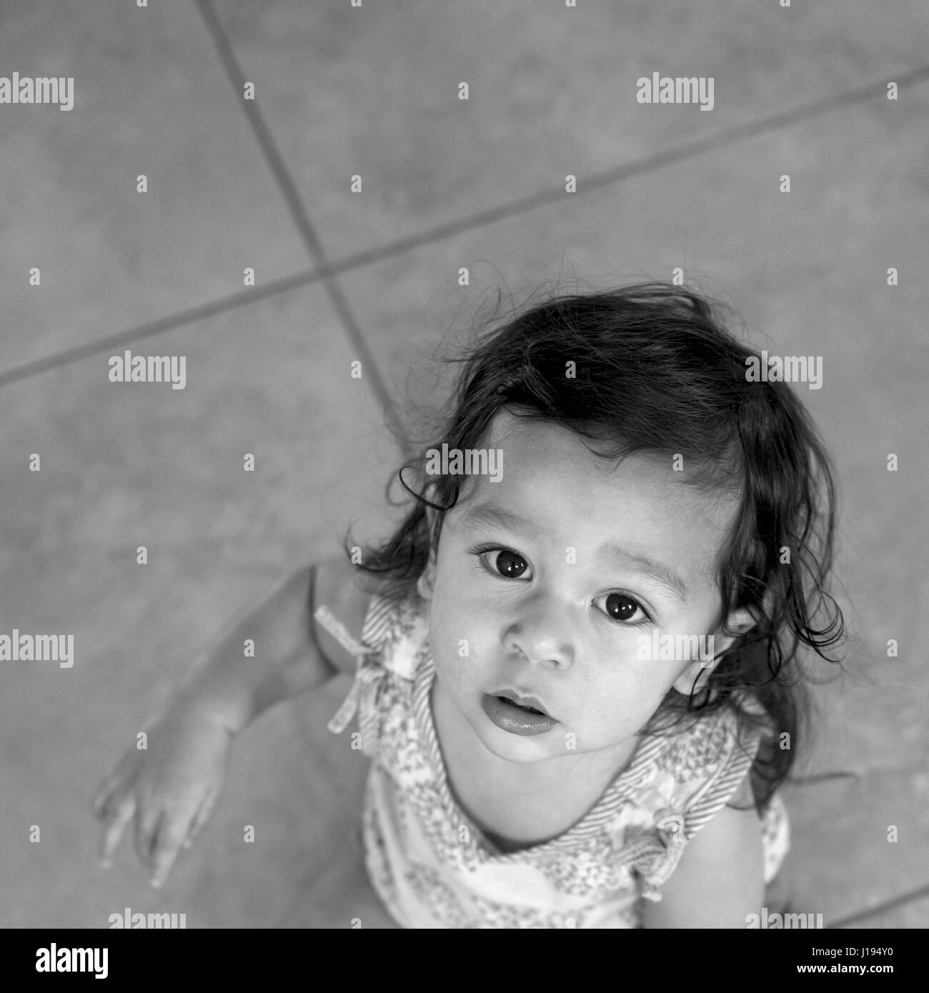 A young girl plays by herself inside Stock Photo - Alamy