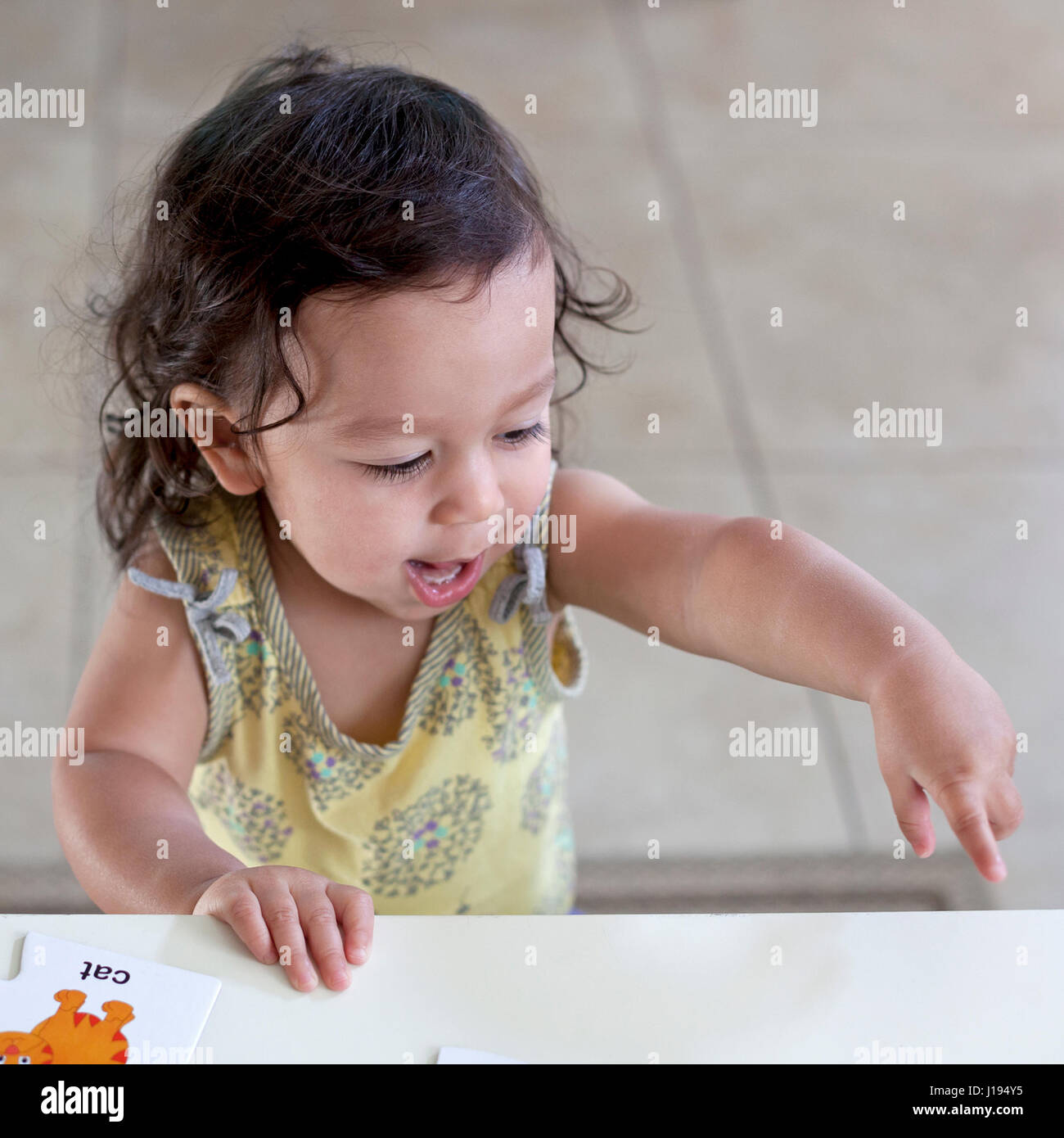 A young girl plays by herself inside Stock Photo - Alamy