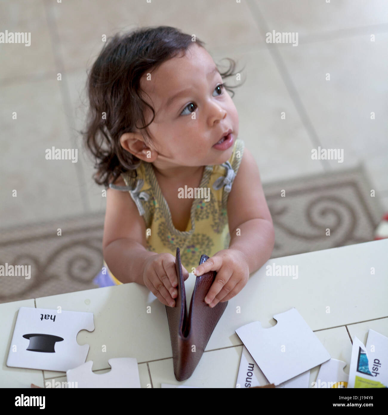 A young girl plays by herself inside Stock Photo - Alamy