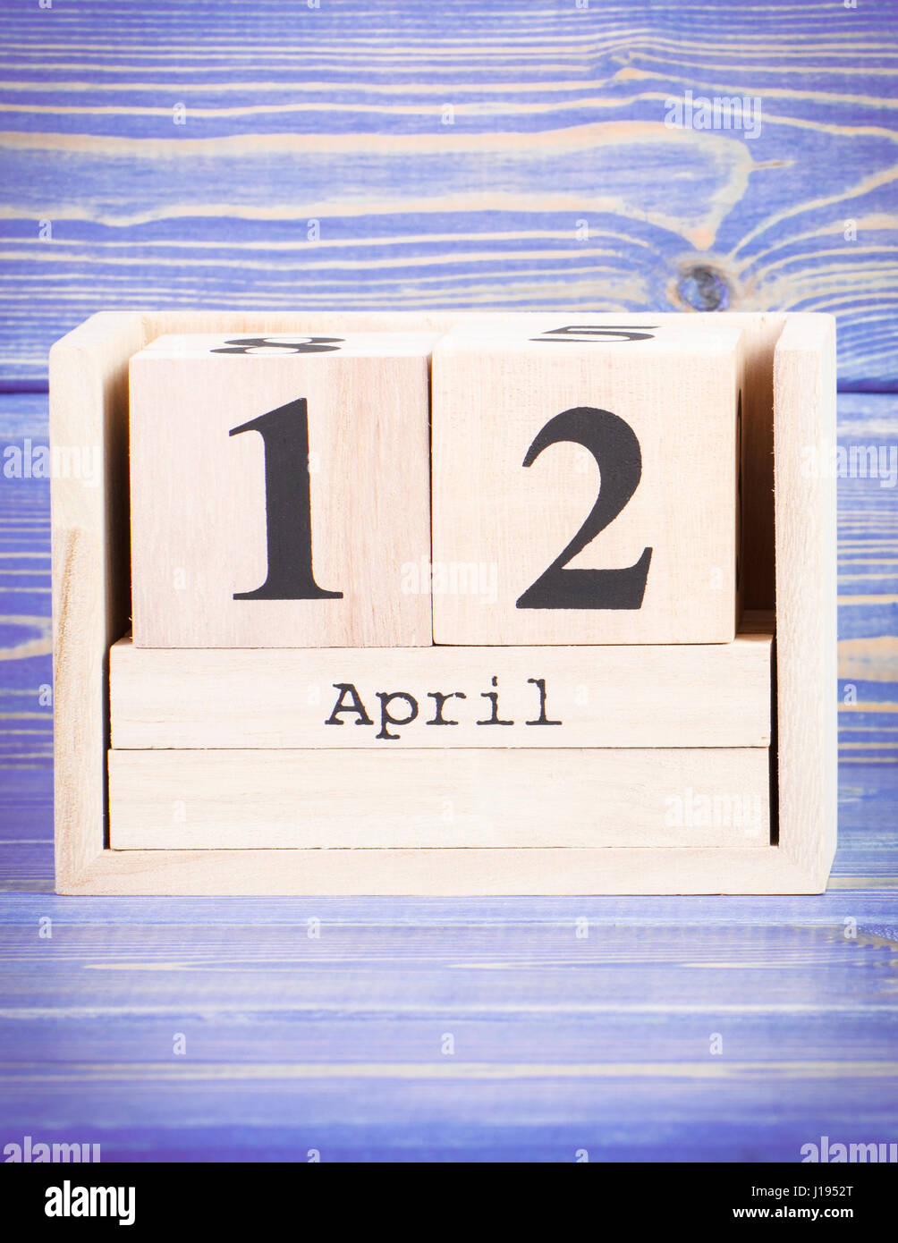 April 12th. Date of 12 April on wooden cube calendar, purple board as ...