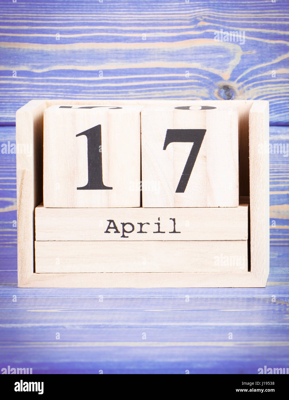 April 17th. Date of 17 April on wooden cube calendar, purple board as ...