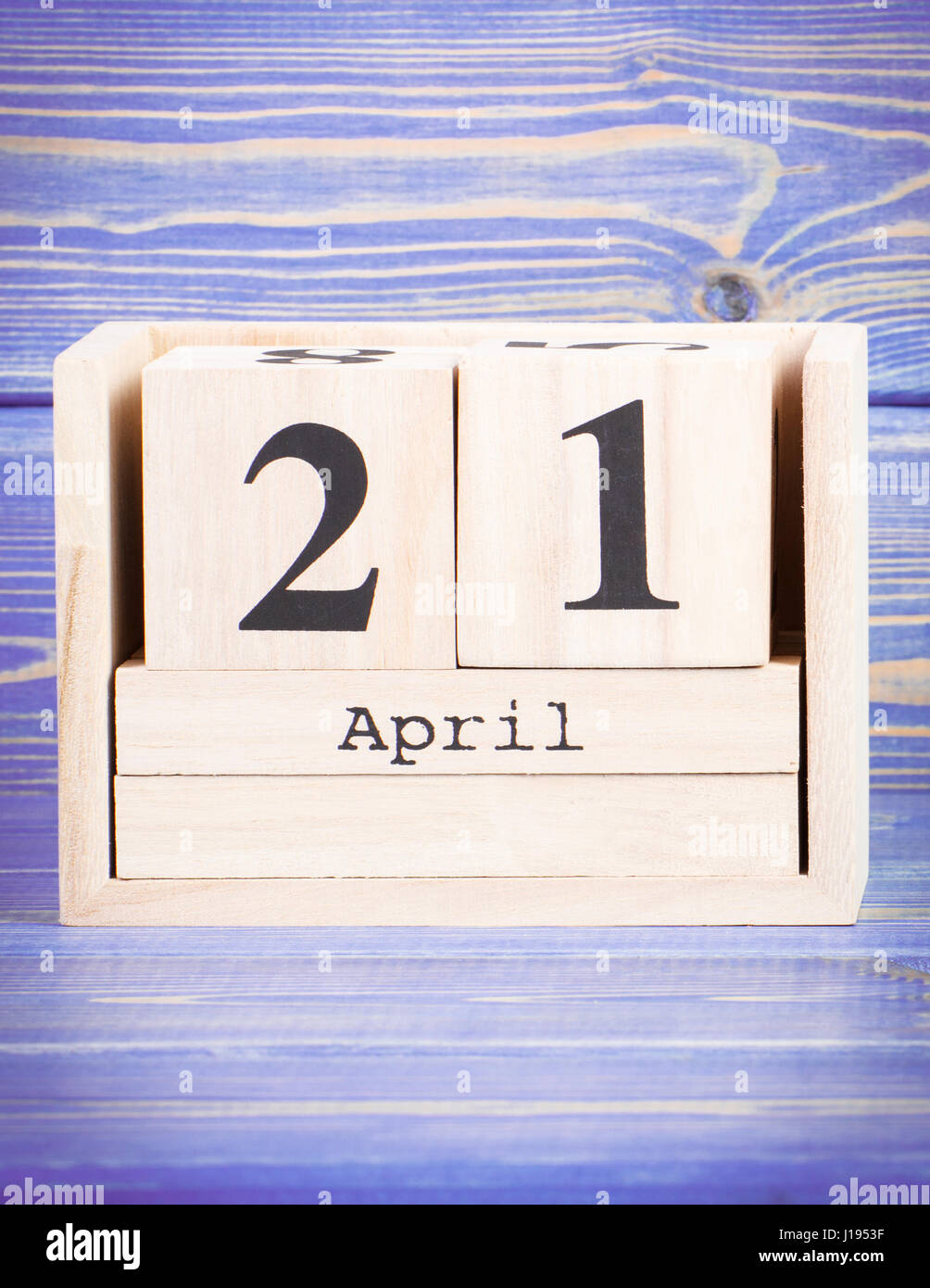 April 21th. Date of 21 April on wooden cube calendar, purple board as ...