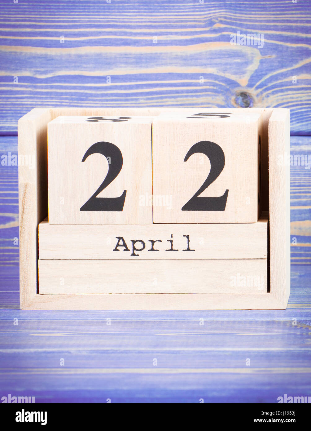 April 22th. Date of 22 April on wooden cube calendar, purple board as ...