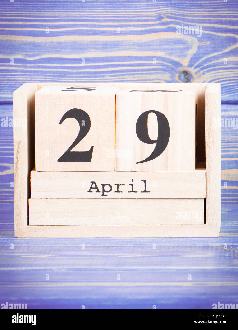 April 29th. Date of 29 April on wooden cube calendar, purple board as ...