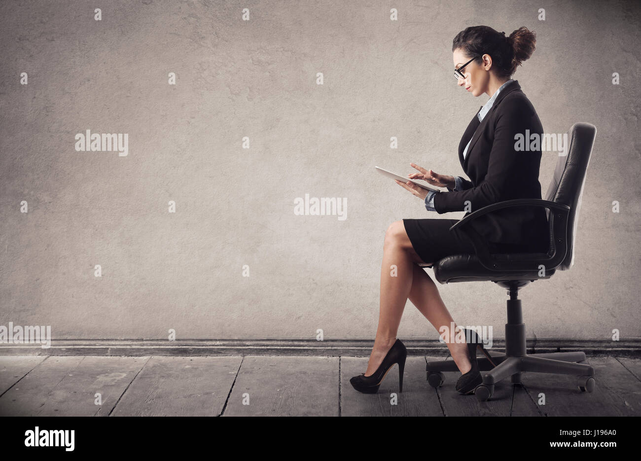 Businesswoman working on chair Stock Photo - Alamy