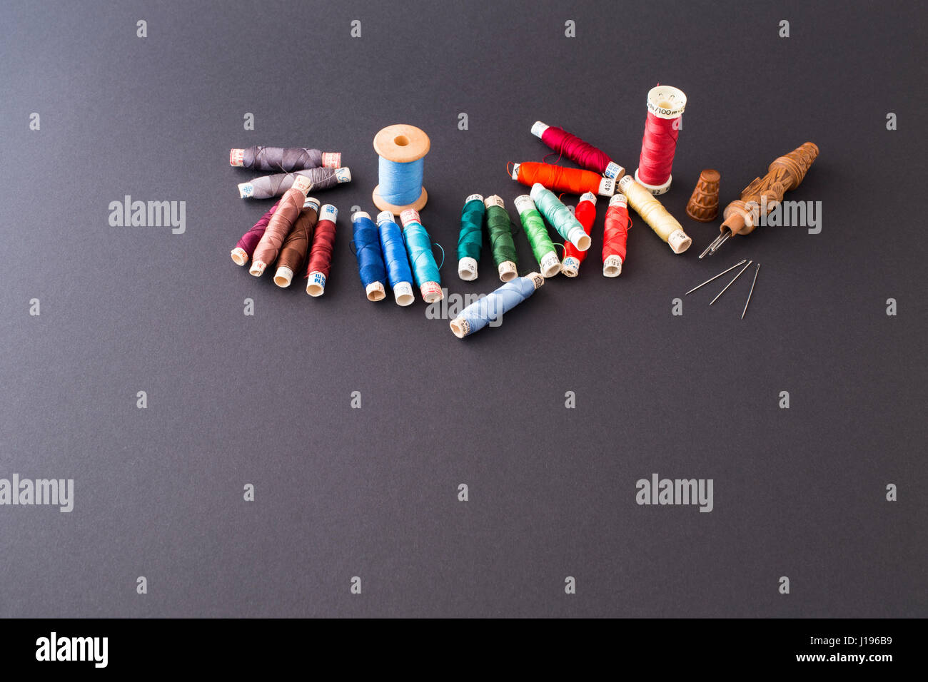 Different rolls with red, blue and green polyester and silk thread ...