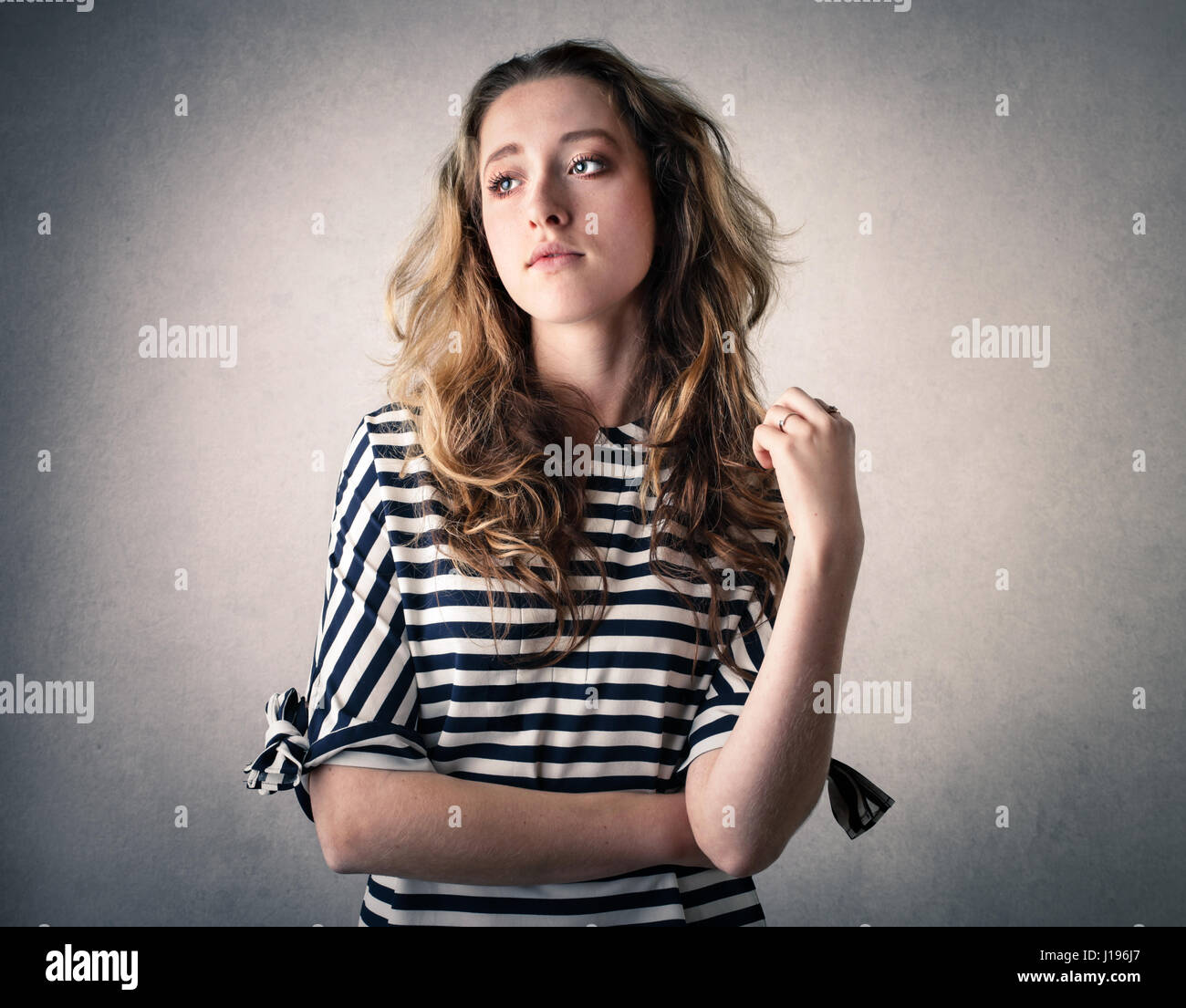 Blond woman crossing her arms Stock Photo - Alamy