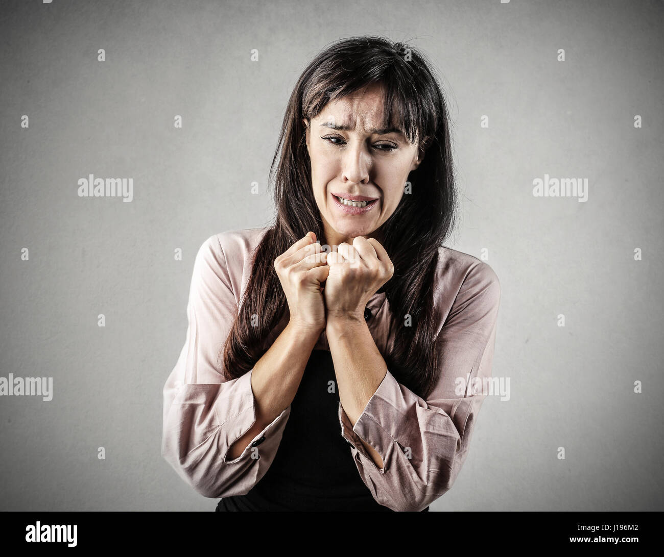 Brunette woman being scared Stock Photo - Alamy