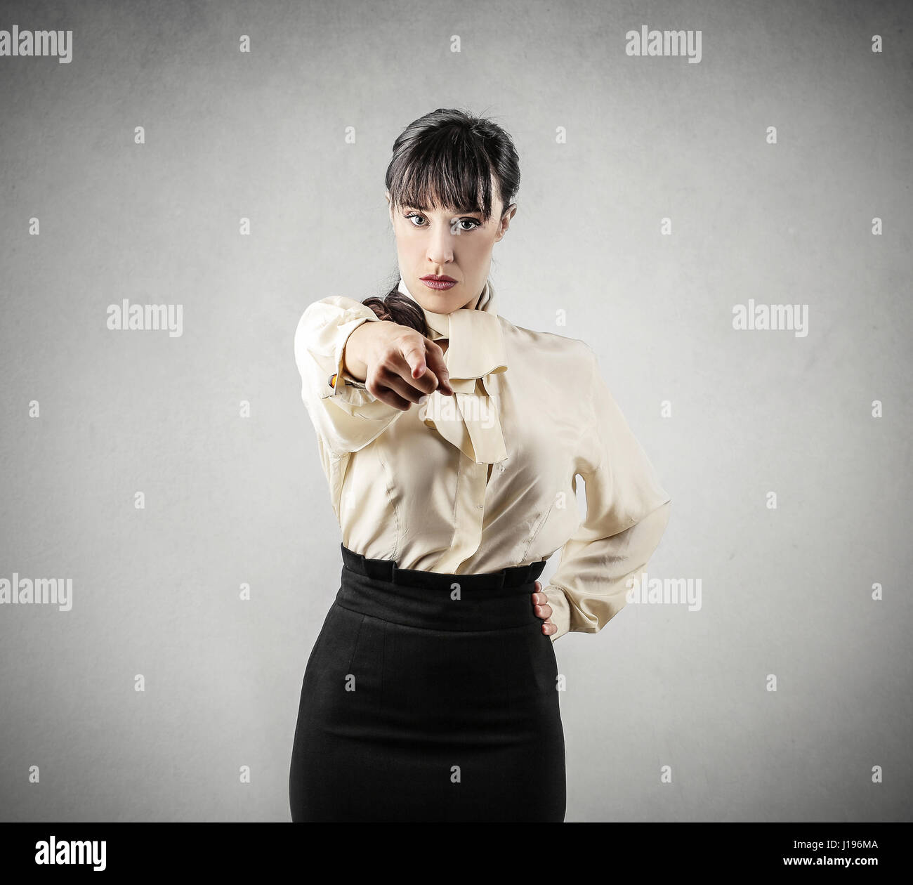 Brunette woman pointing at you Stock Photo - Alamy