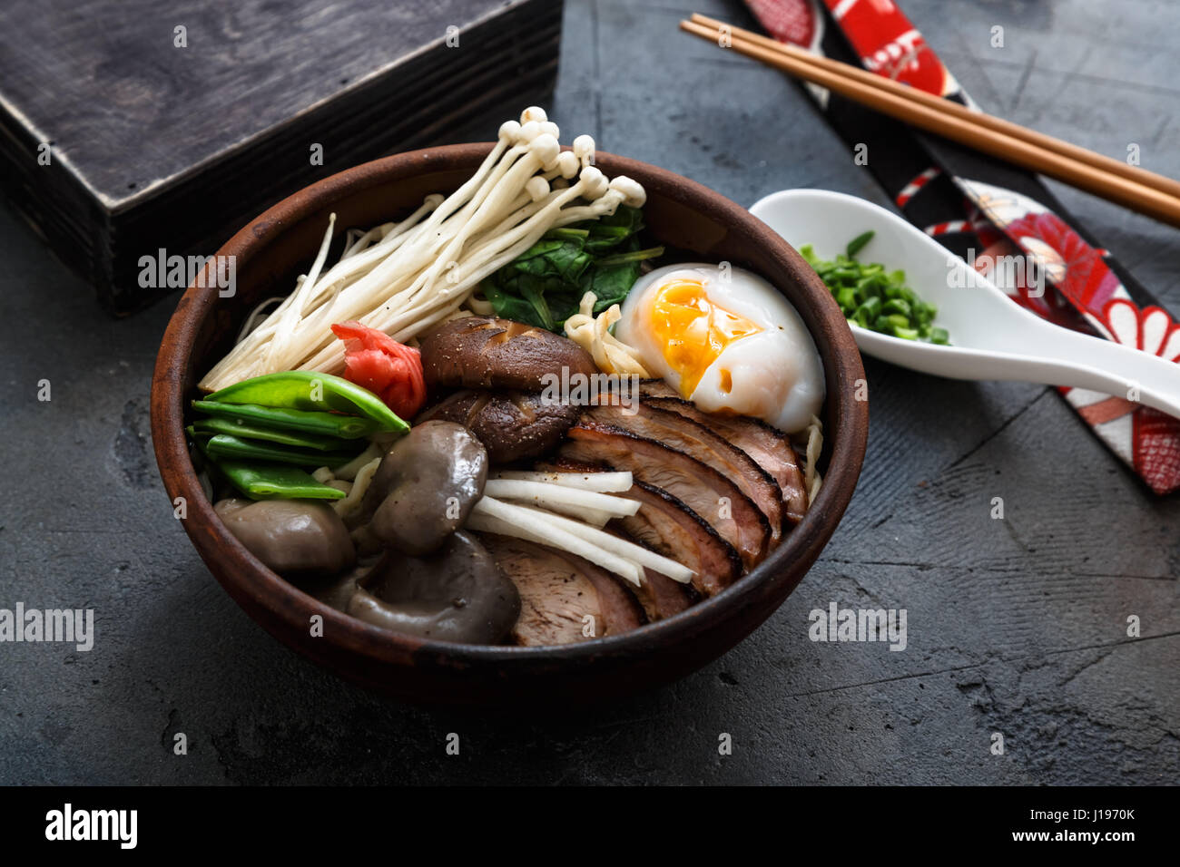 Ramen noodles bowl with egg, enoki, shiitake mushrooms, duck and onion ...