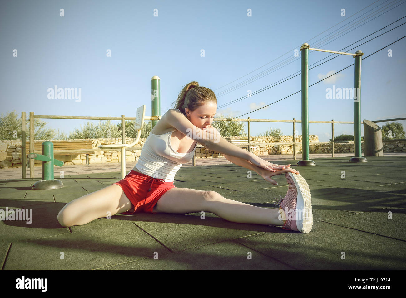 Sporty woman stretching Stock Photo - Alamy