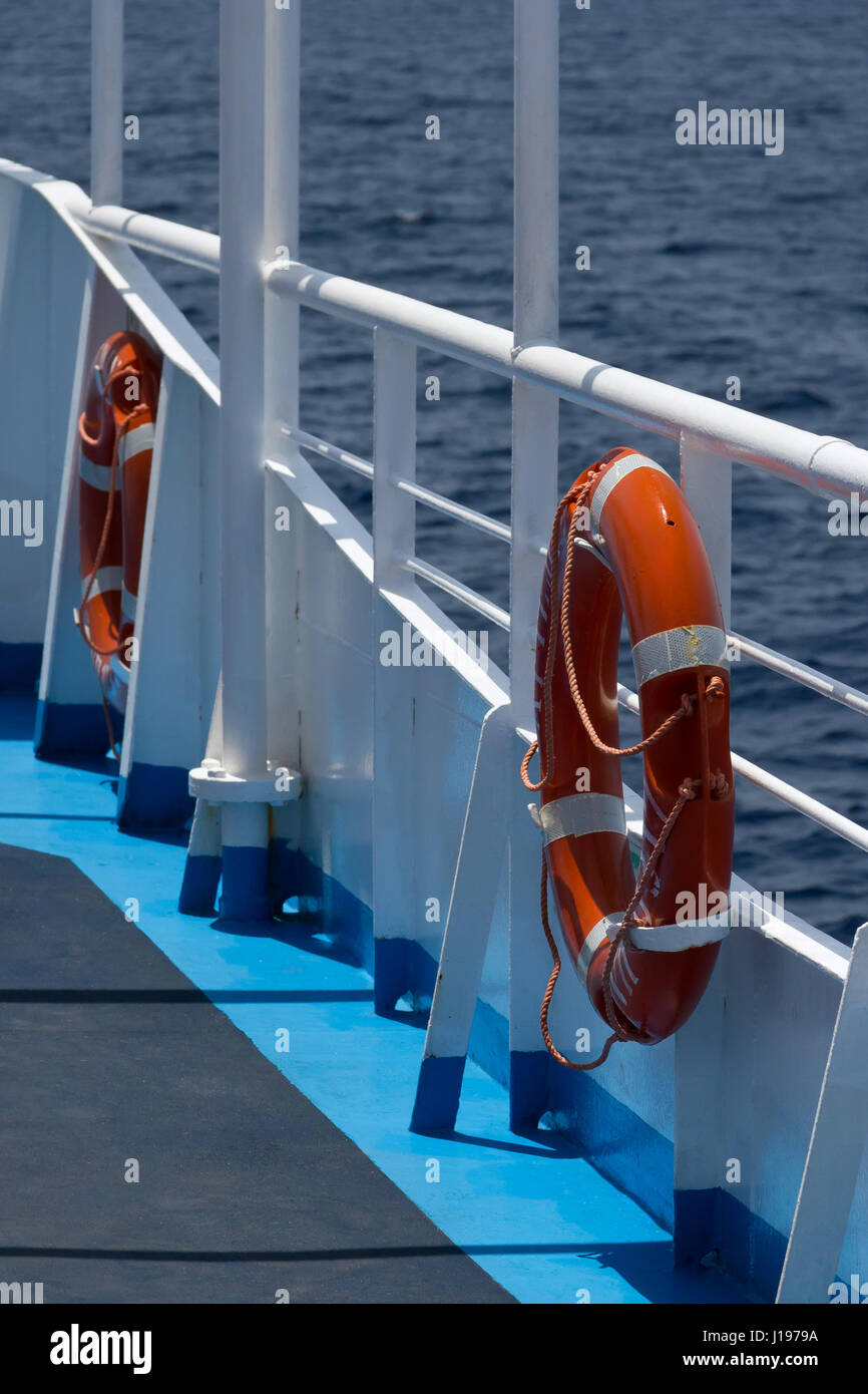 Life bouys - Two lifebuoys on fence of the ship deck with sea in the ...