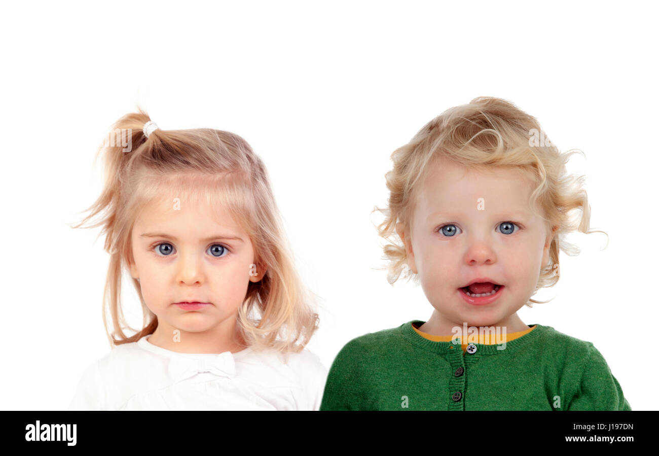 Two caucasian children looking at camera isolated on a white background ...