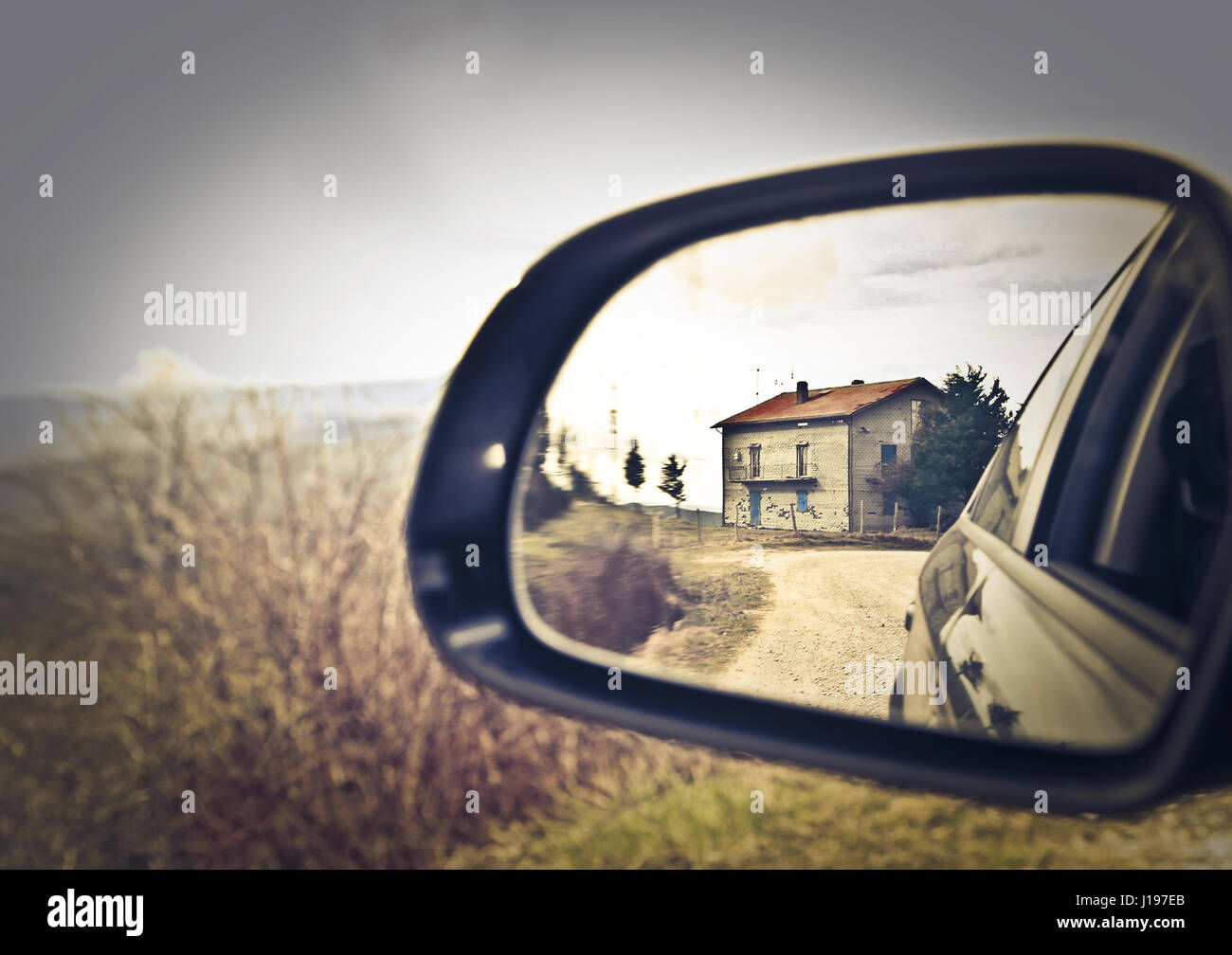 Town in car's rearview mirror Stock Photo - Alamy