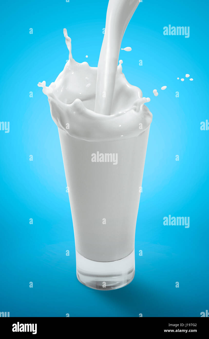 Creamy Milk Splash in Glass Over Blue Background Stock Photo - Alamy