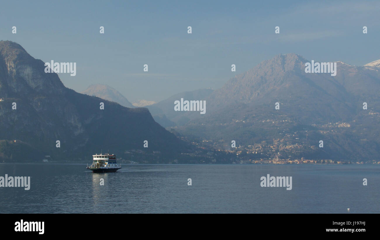 Ferry sailing through a mountain lake. Lake Como, Italy Stock Photo - Alamy