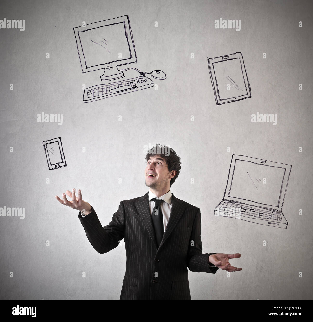 Businessman with drawings of electronics Stock Photo - Alamy