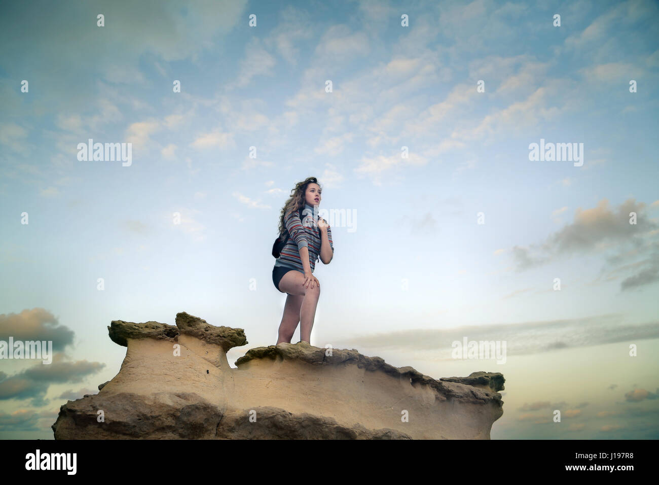 Woman walking on cliff Stock Photo - Alamy