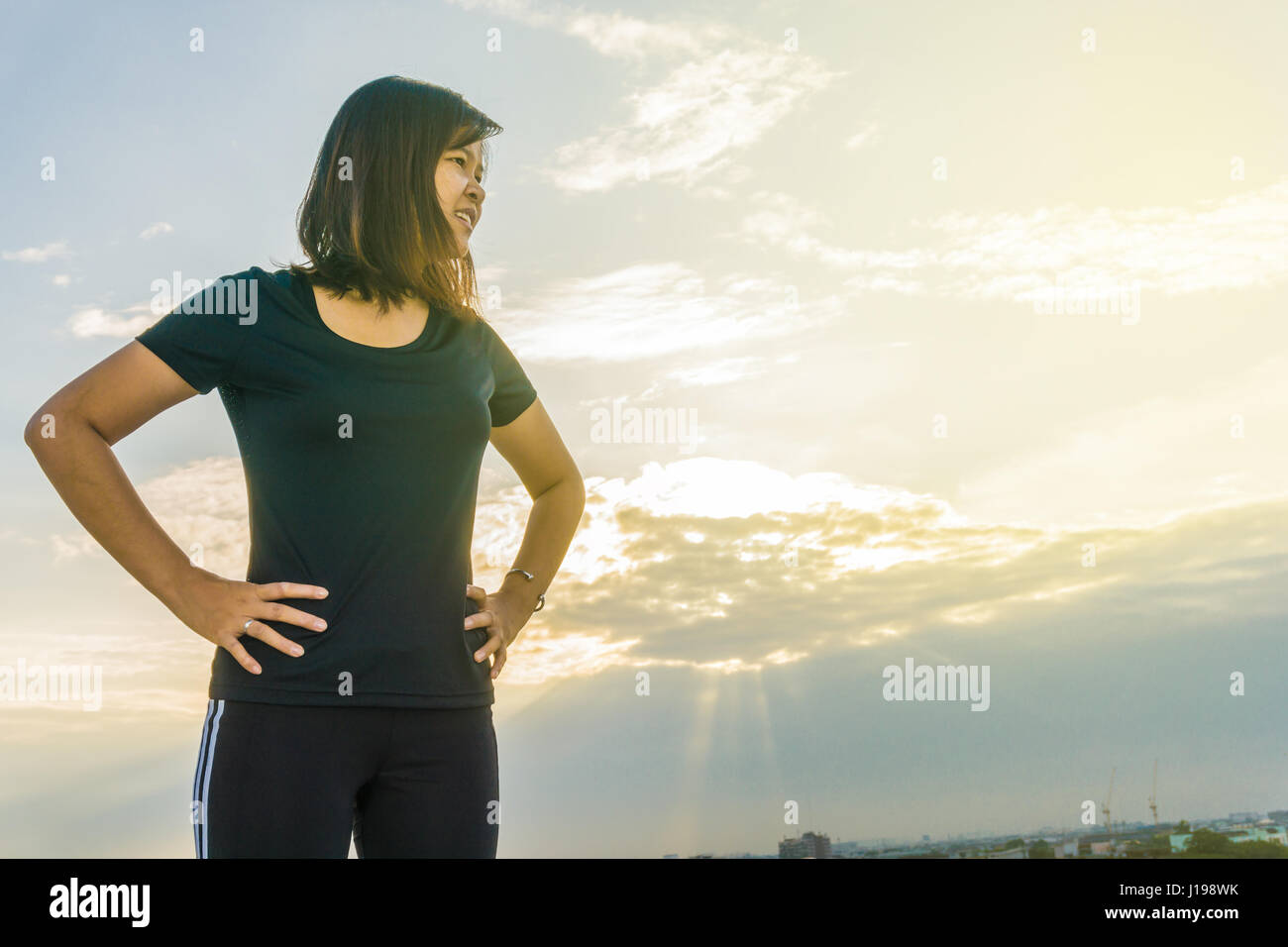 Fitness runner body closeup doing warm-up routine on roof top building ...