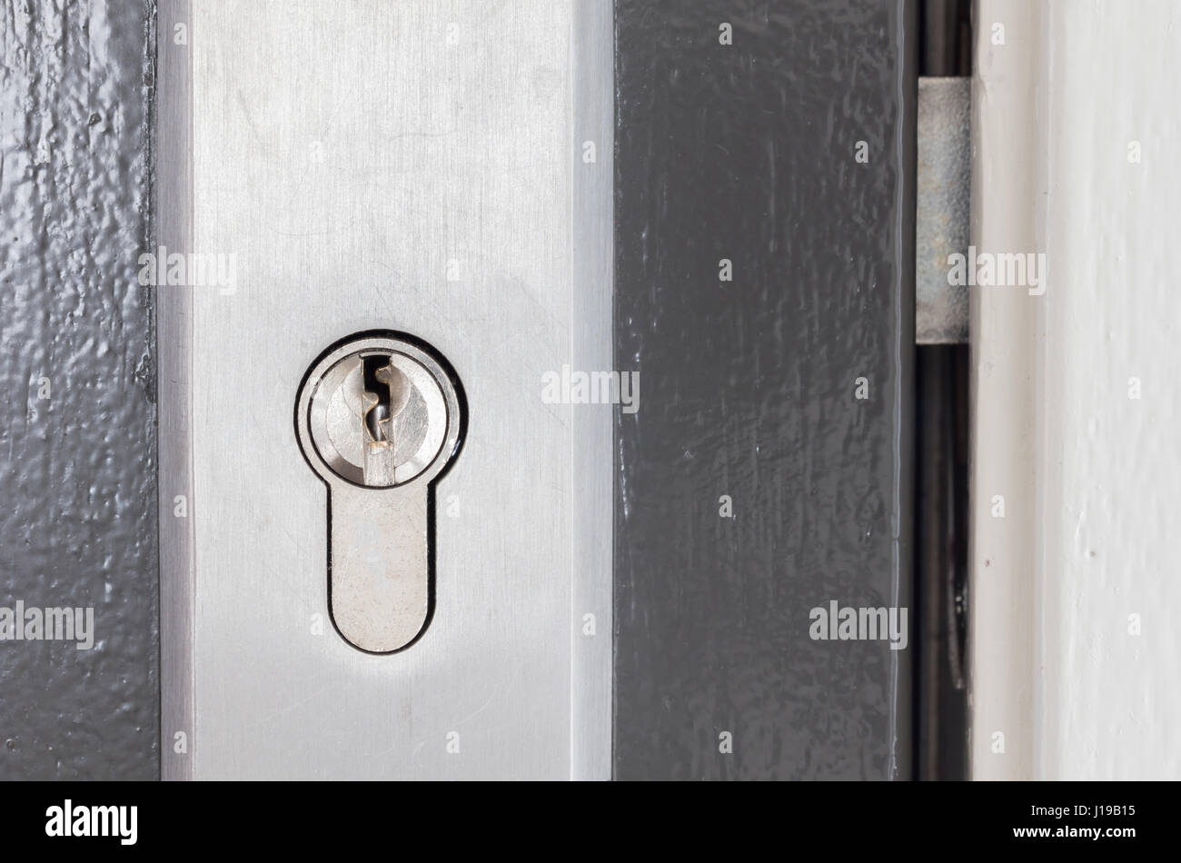 Cylinder lock closeup, shiny chrome, cylinder in a grey door Stock ...