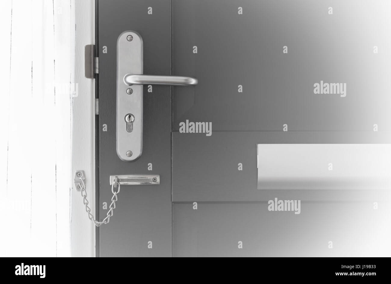 Door chain on a grey door, security measures Stock Photo - Alamy