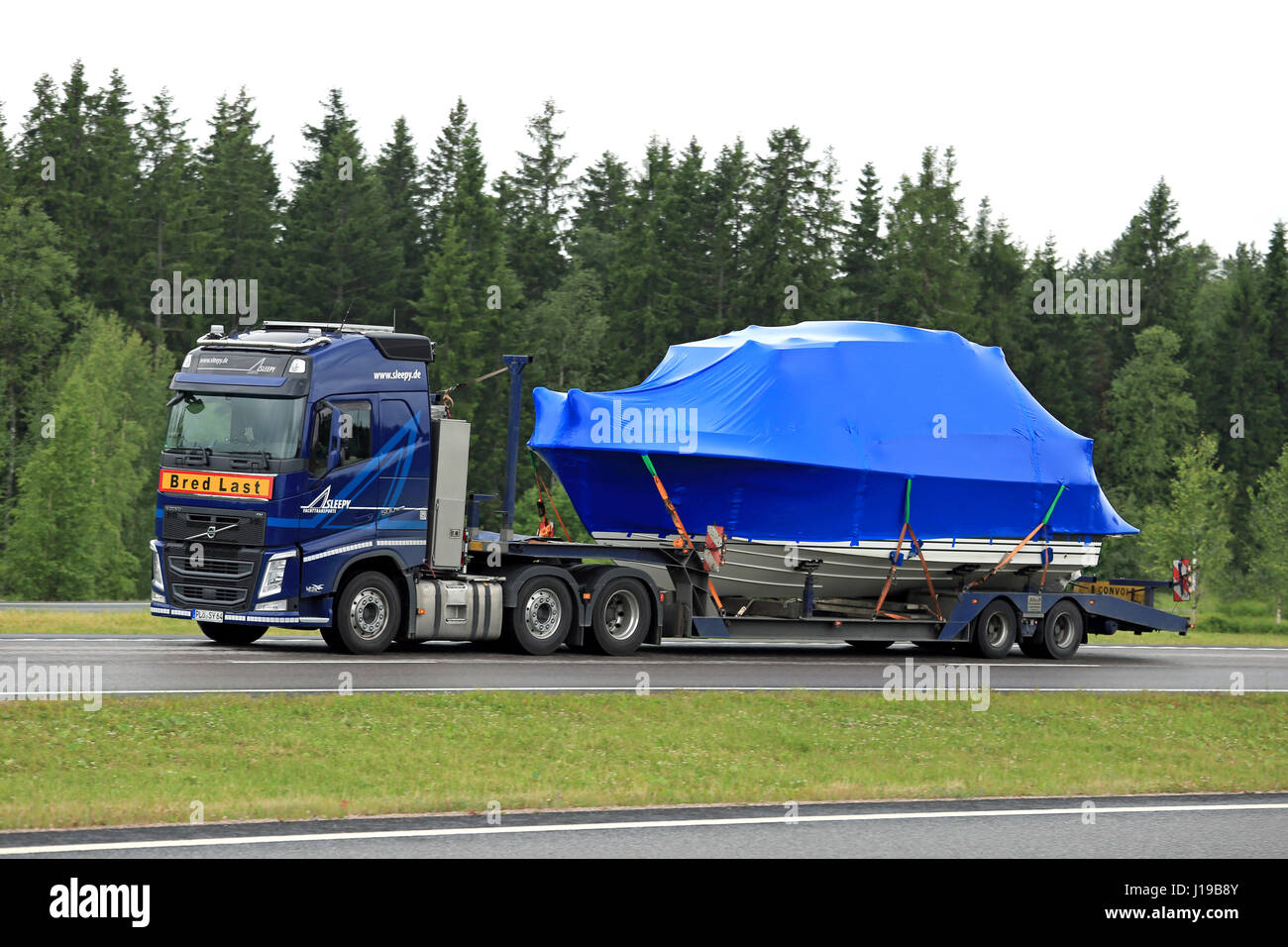 PAIMIO, FINLAND - JUNE 23, 2016: Blue Volvo FH semi truck hauls a boat ...