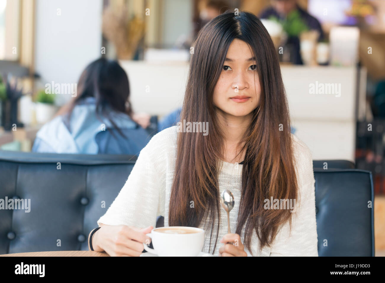 Happy asian female with latte coffee in cafe during free time at ...