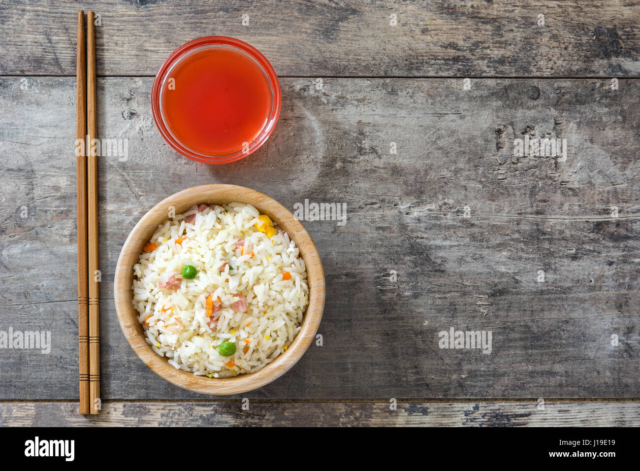 Fried chinese rice with vegetables on wooden background Stock Photo - Alamy