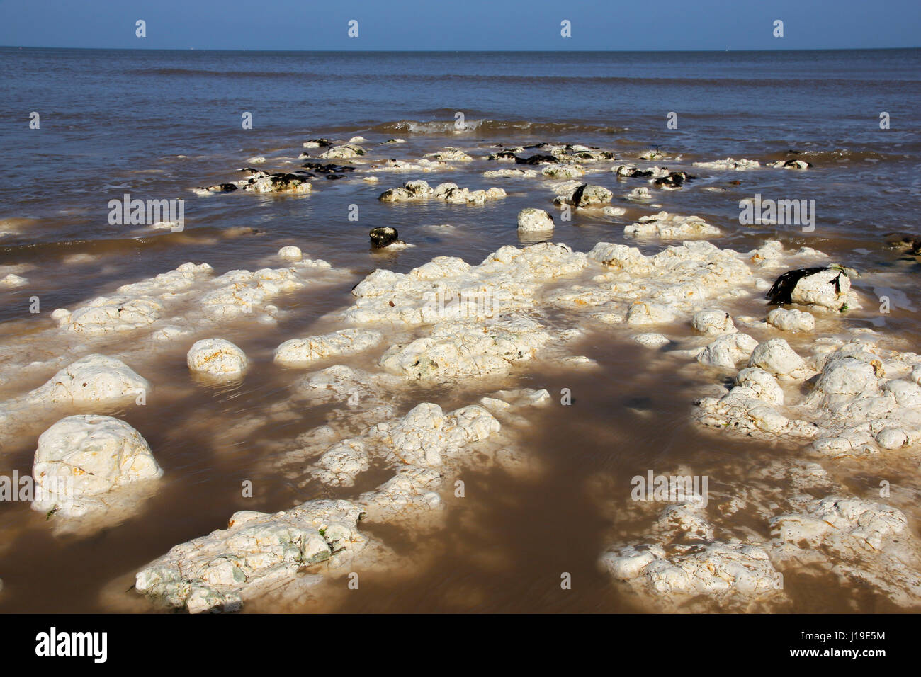 rocks on Sheringham beach Stock Photo - Alamy