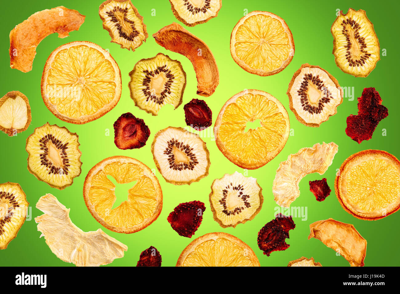 Dried Fruits on green background Stock Photo - Alamy