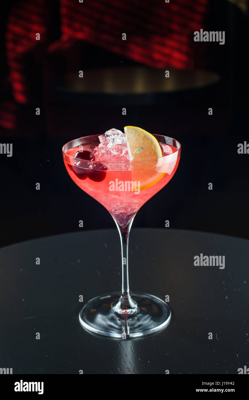 Barman at work, preparing cocktails. pouring cosmopolitan to cocktail ...