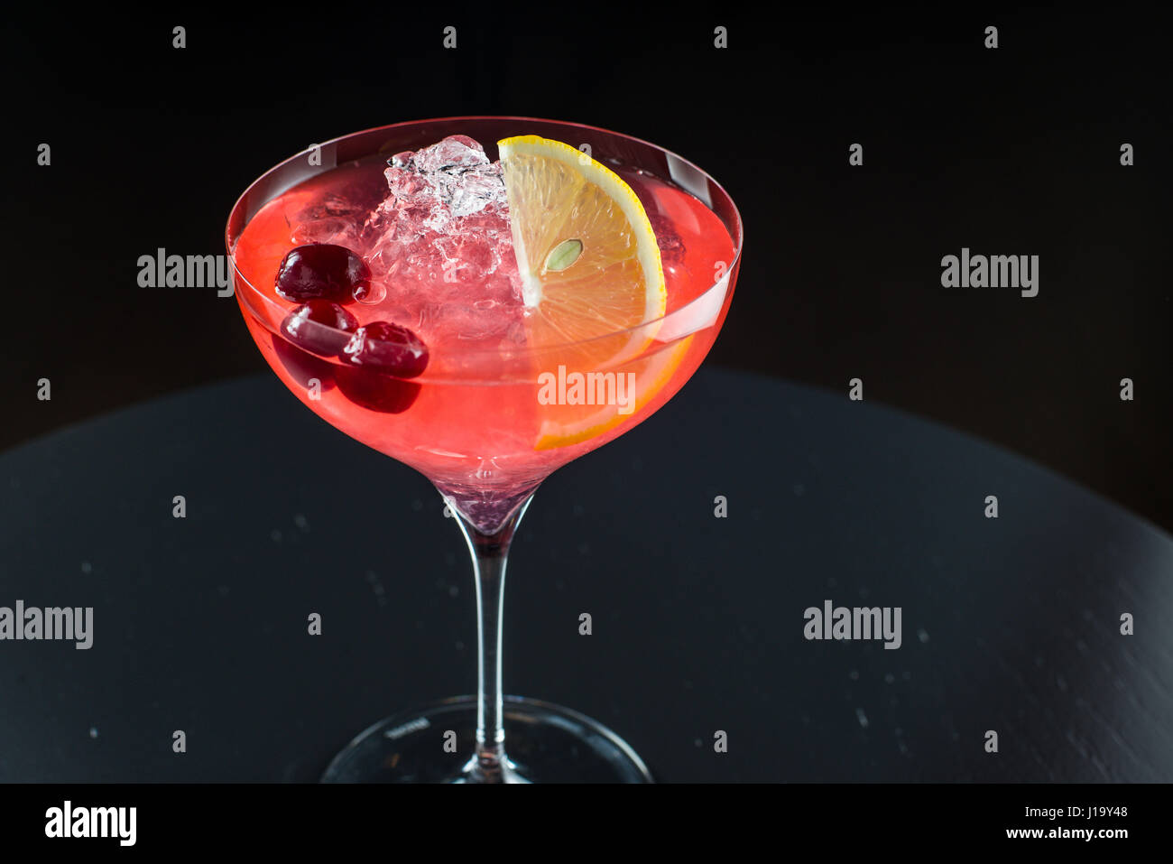 Barman at work, preparing cocktails. pouring cosmopolitan to cocktail ...
