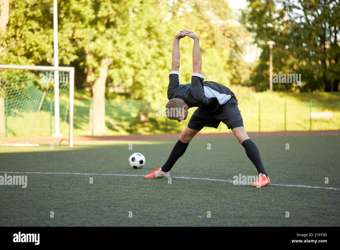 soccer player stretching leg on field football Stock Photo - Alamy