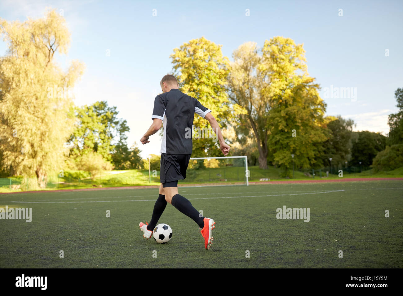 Footballer dribbling ball hi-res stock photography and images - Alamy