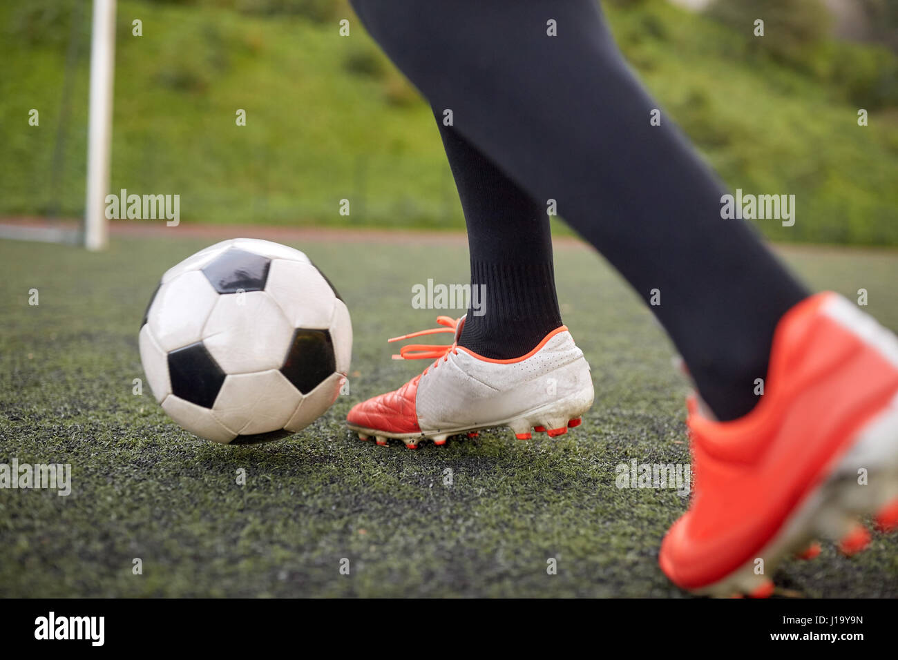 soccer player playing with ball on football field Stock Photo - Alamy