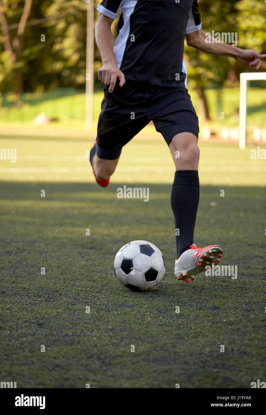 soccer player playing with ball on football field Stock Photo - Alamy