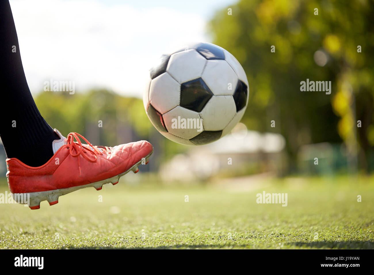 soccer player playing with ball on football field Stock Photo - Alamy